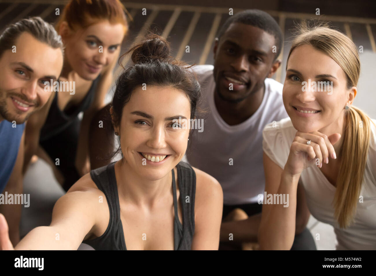 Sporty multiracial friends taking group selfie holding looking a Stock Photo - Alamy