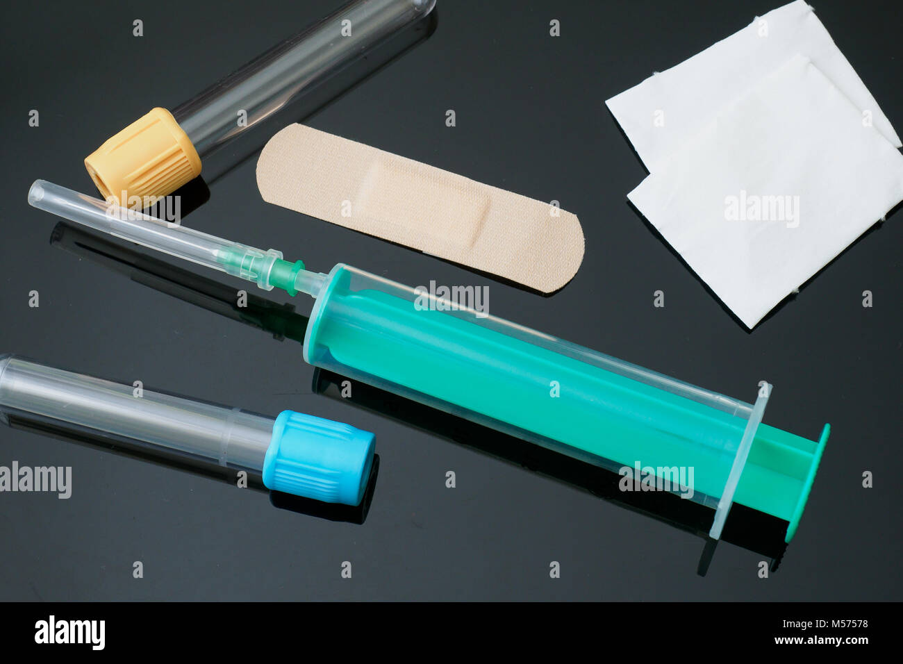Syringe with test tubes on black background Stock Photo - Alamy