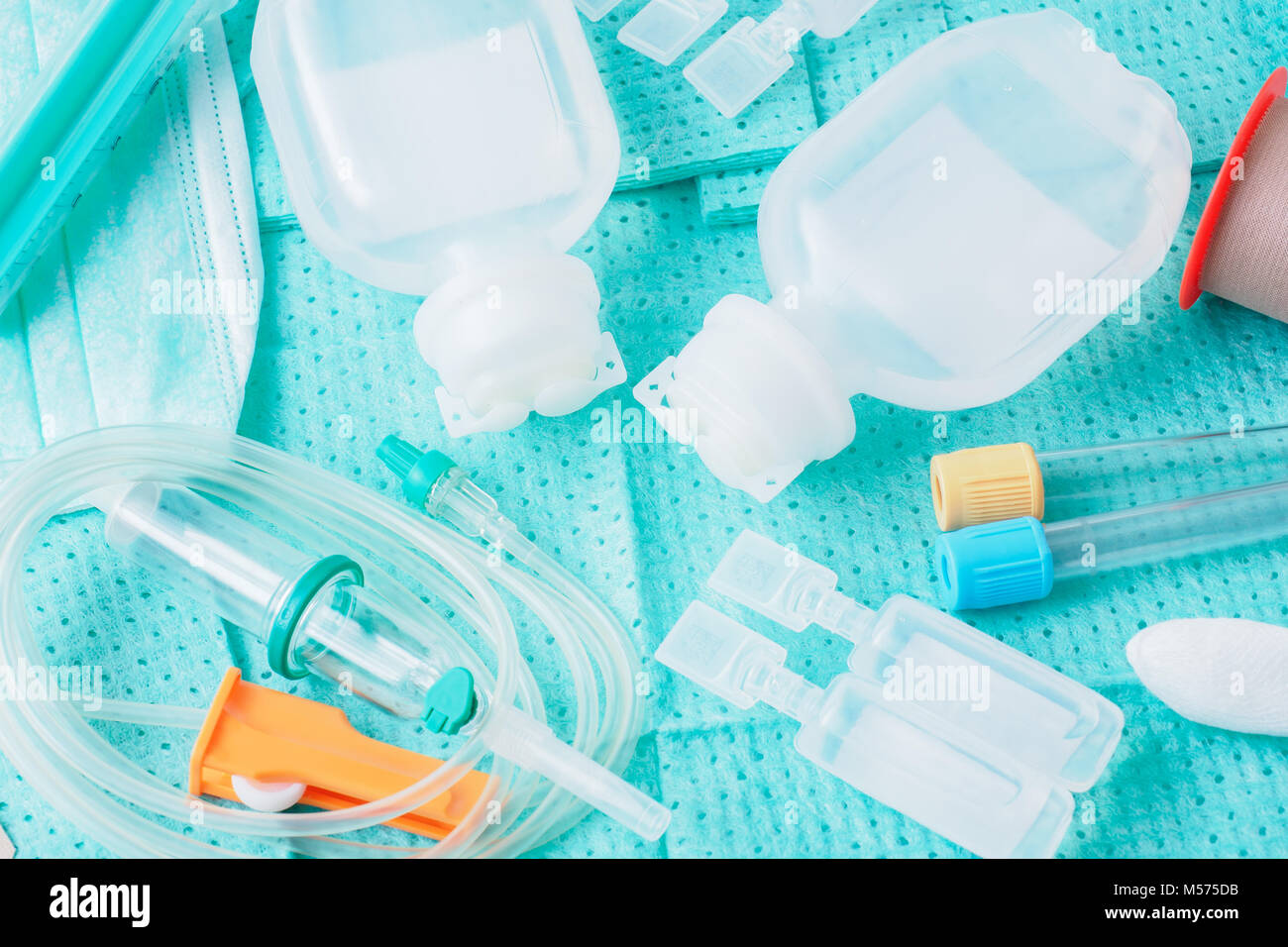 Disposable infusion set on green background Stock Photo - Alamy