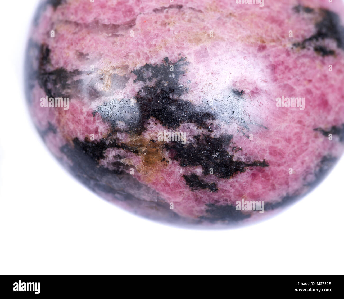 Rhodonite polished palm stone from Madagascar isolated on white ...