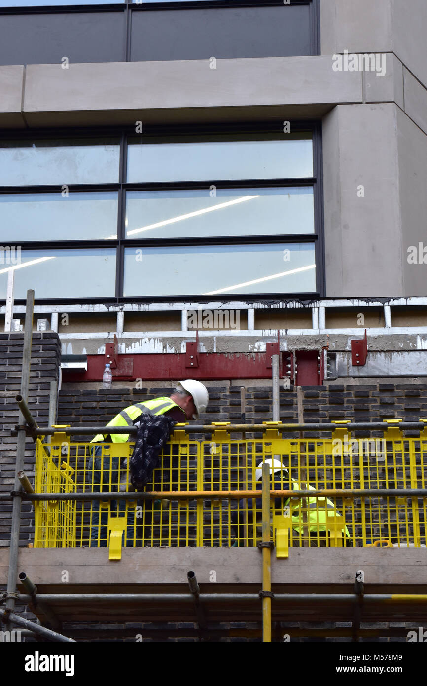 Construction workers on a building site in central london working ...