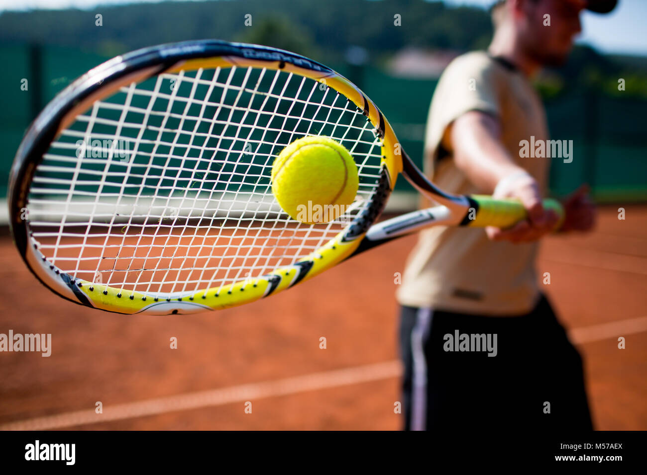 Tennis player in action on a tennis court Stock Photo - Alamy