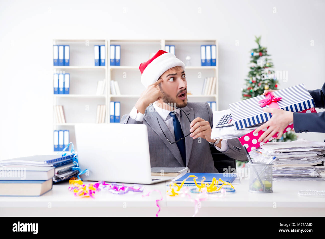 Young businessman celebrating christmas in the office Stock Photo - Alamy