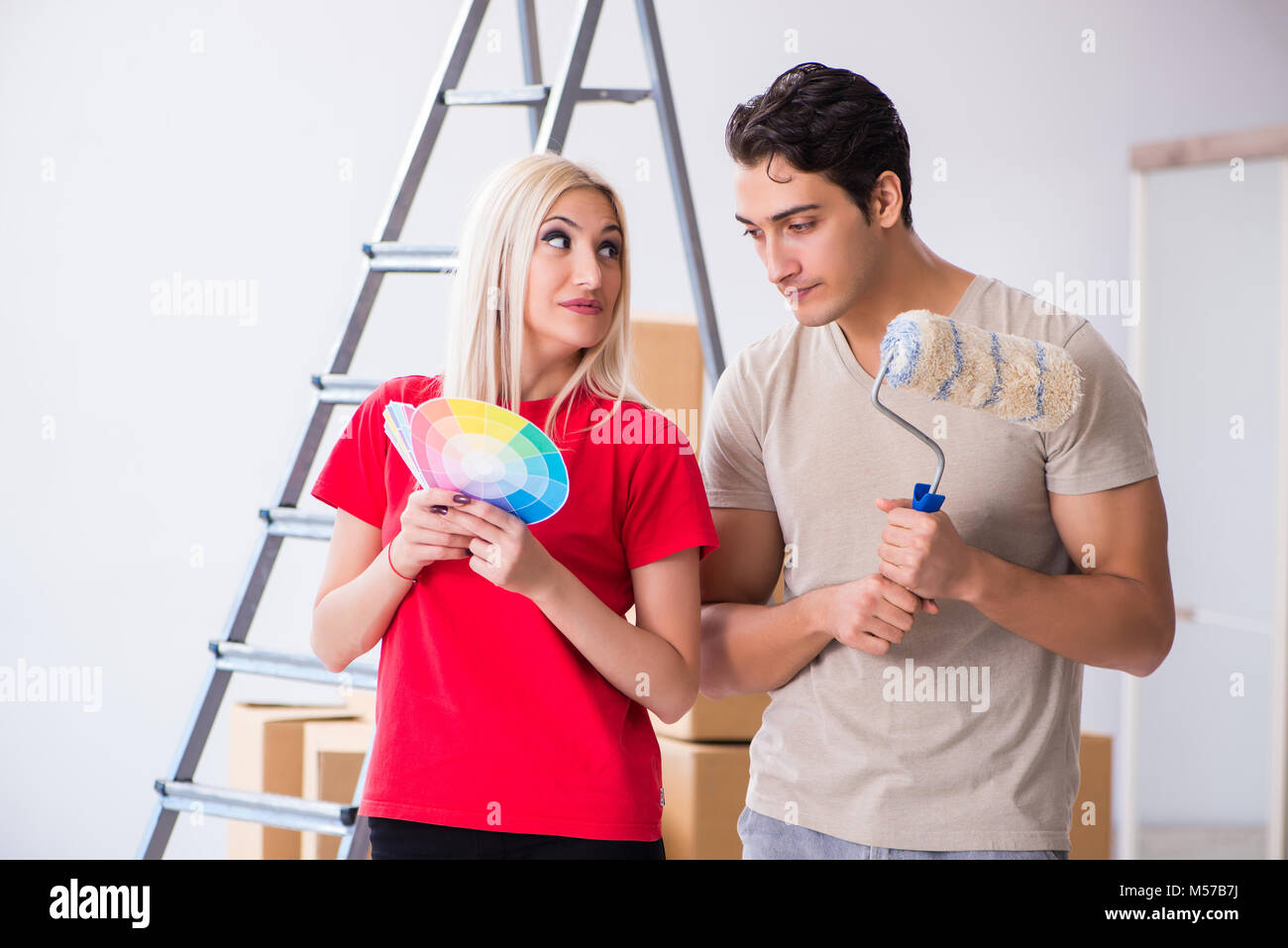 Young family doing painting job during home renovation Stock Photo - Alamy