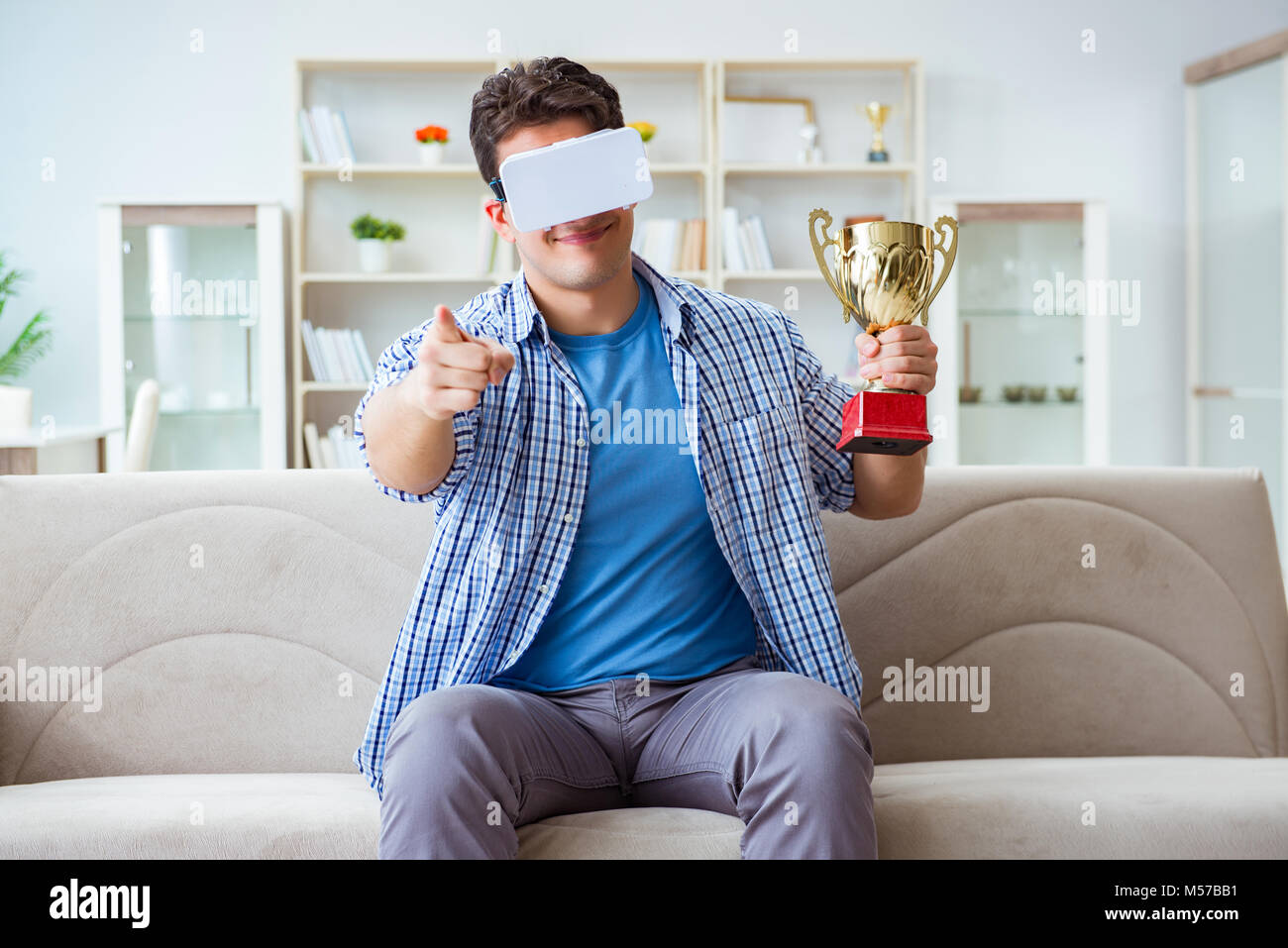 Man wearing virtual reality VR glasses receiving prize cup award Stock ...