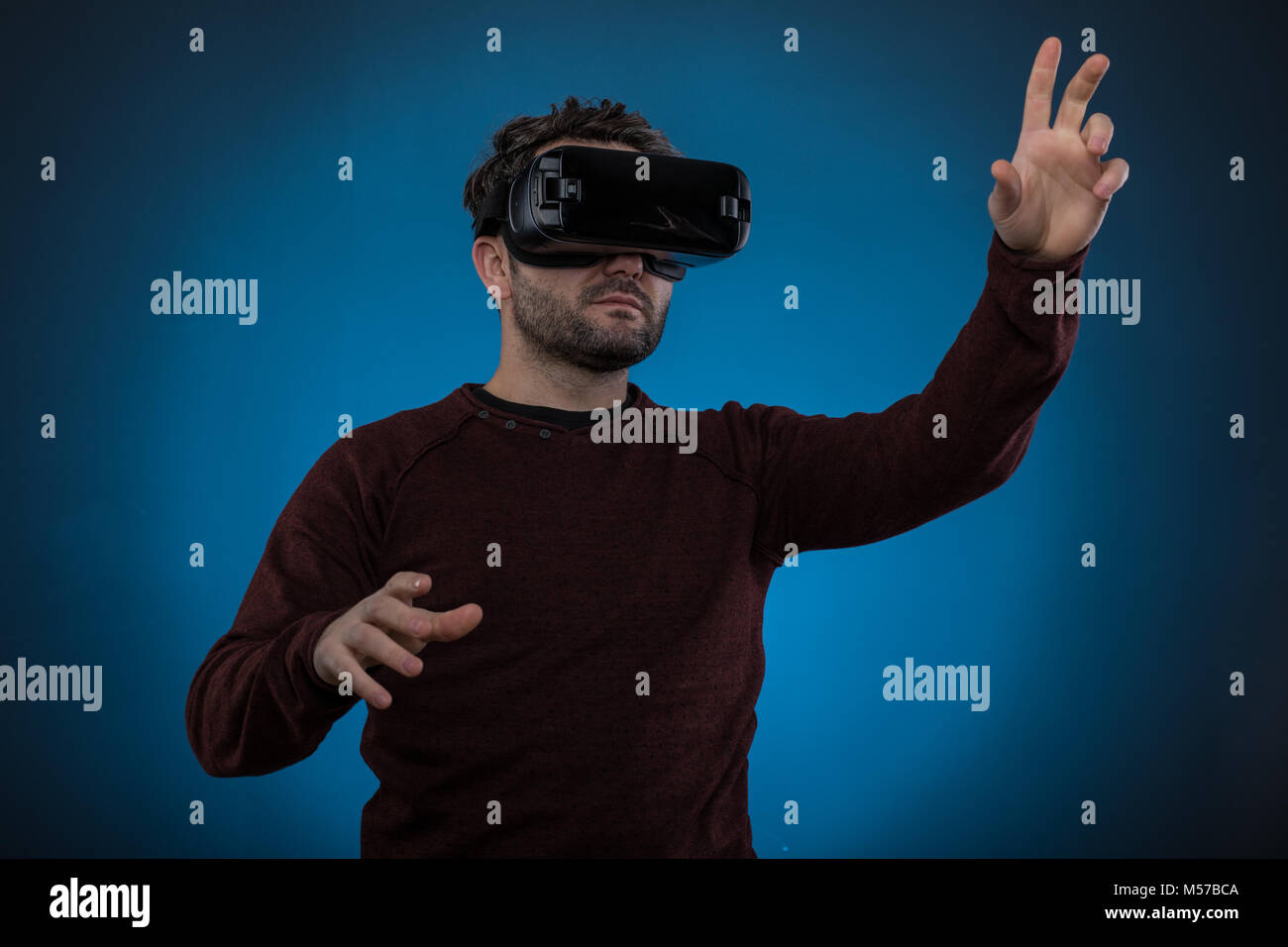 Handsome man wearing future technology glasses ,Studio shot, blue ...