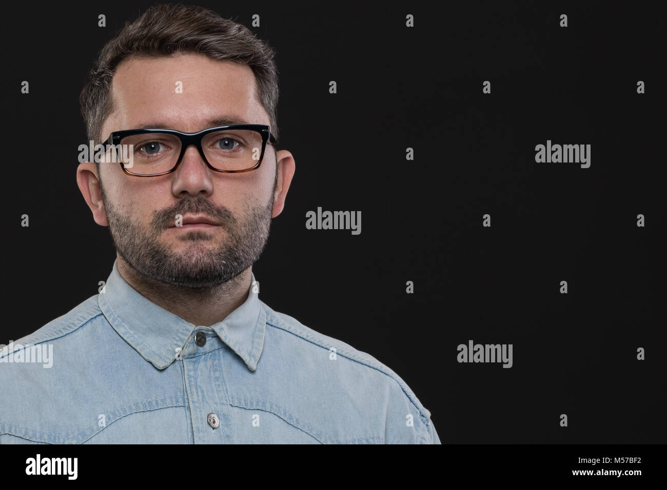 Handsome man in texas shirt and glasses ,Studio shot, black background ...
