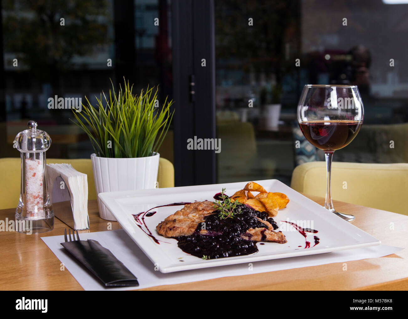 steak entrecote on pork bone with blueberry sauce. meat with berry ...