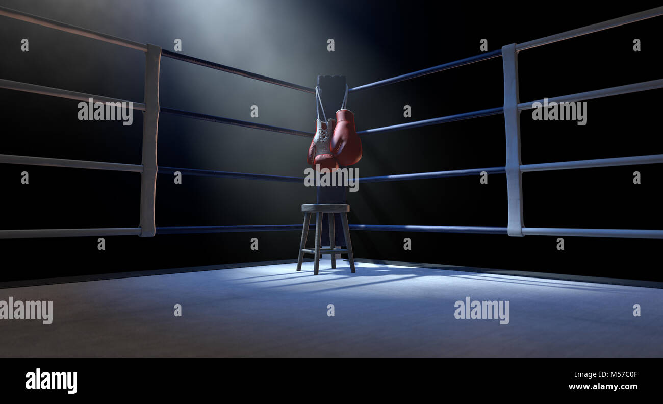 The blue corner of a boxing ring with gloves hanging on a pole spotlit ...