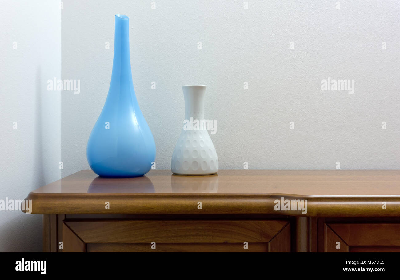 Two elegant blue and white ceramic vases on a wooden chest Stock Photo ...