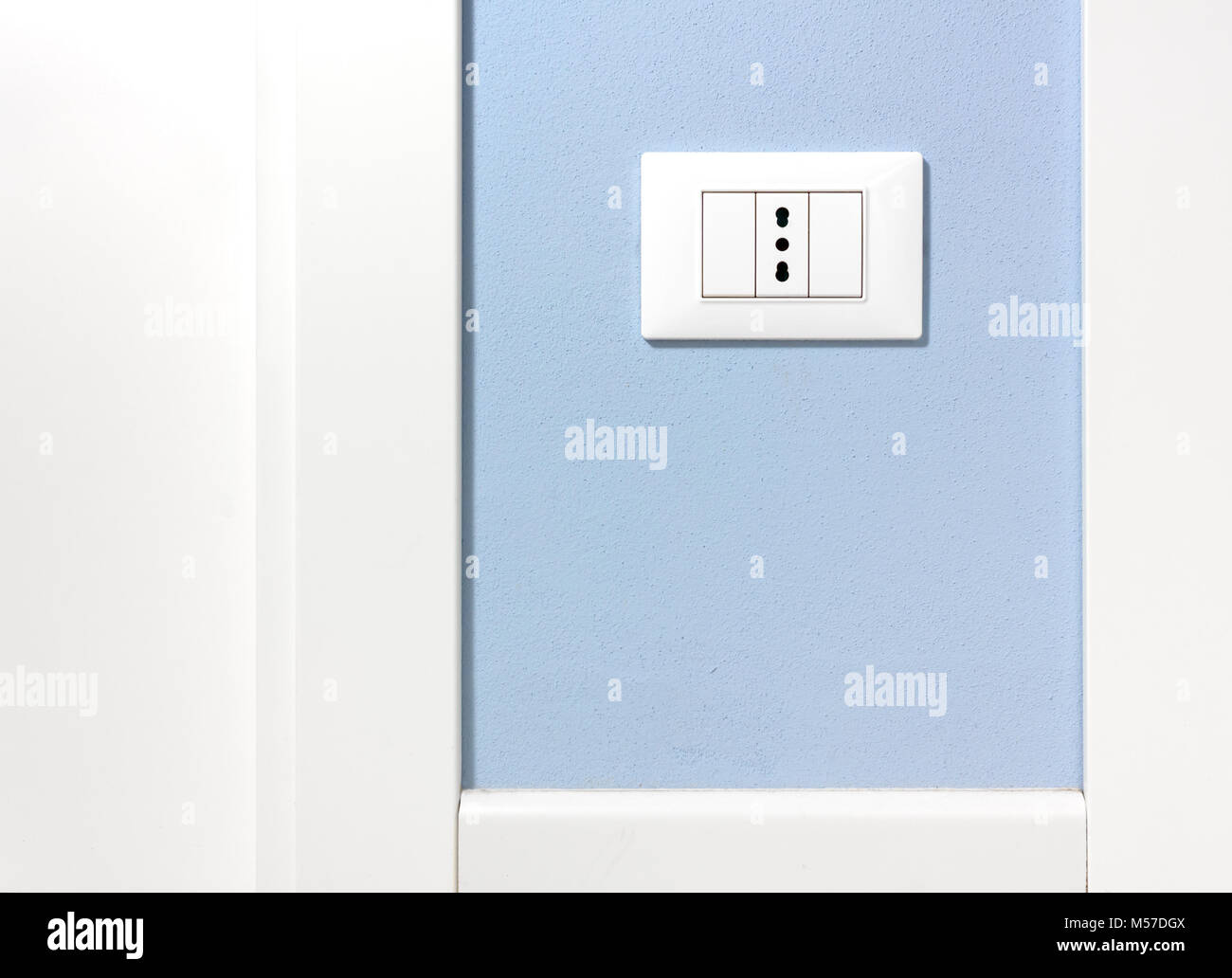 Empty wall socket on a light blue interior wall Stock Photo - Alamy