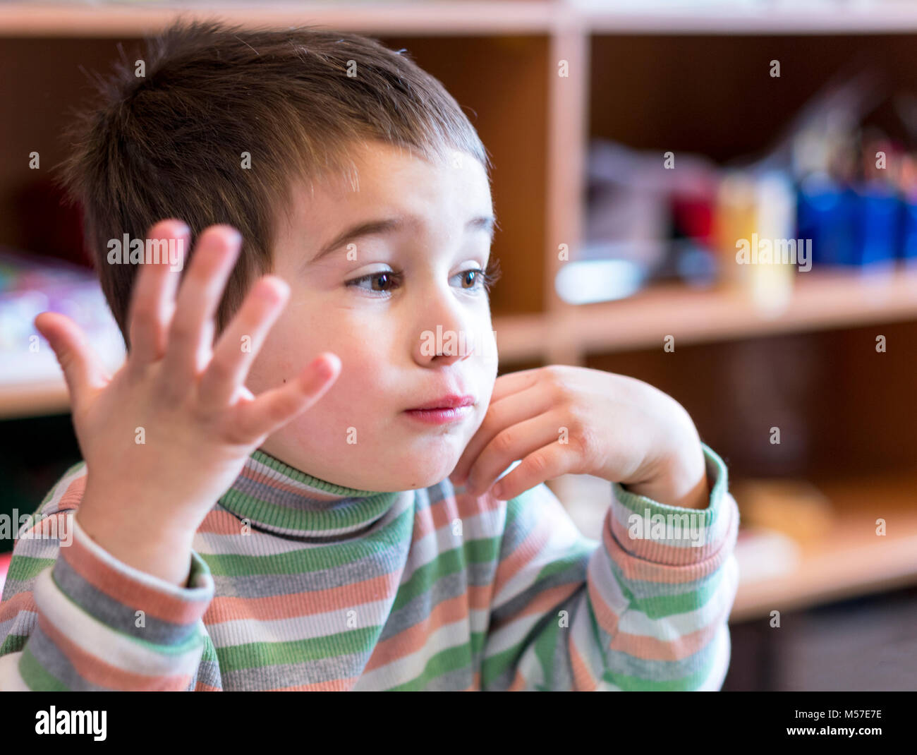 A boy at the age of 5 raising hand to the kindergarten Stock Photo - Alamy