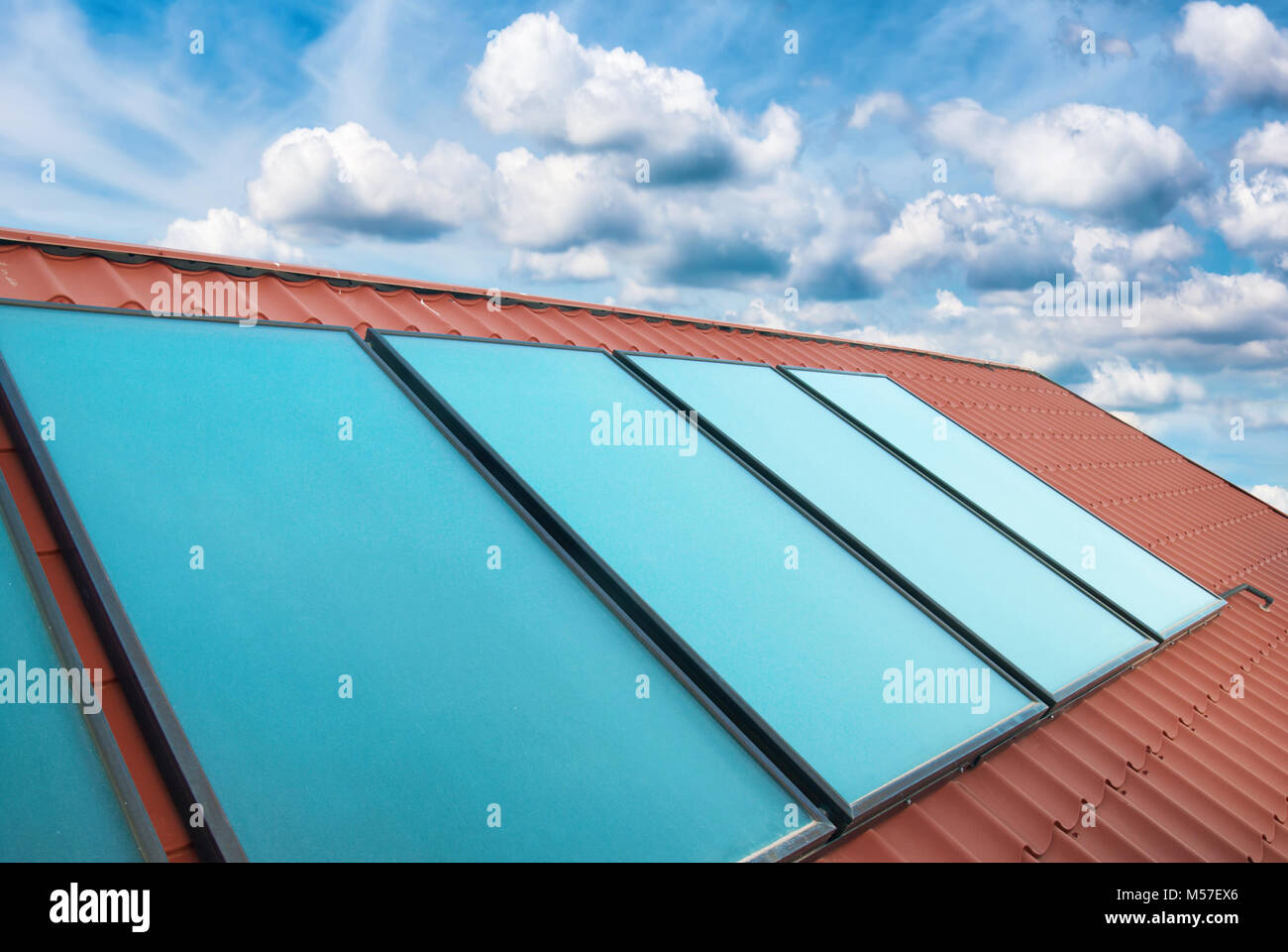 Solar cells on the red house roof Stock Photo - Alamy