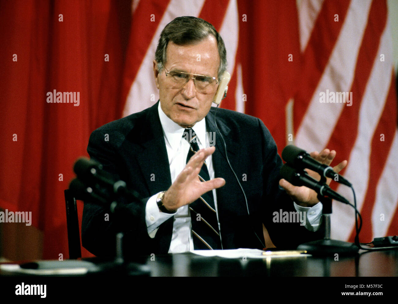 United States President George H.W. Bush answers a reporter's question ...