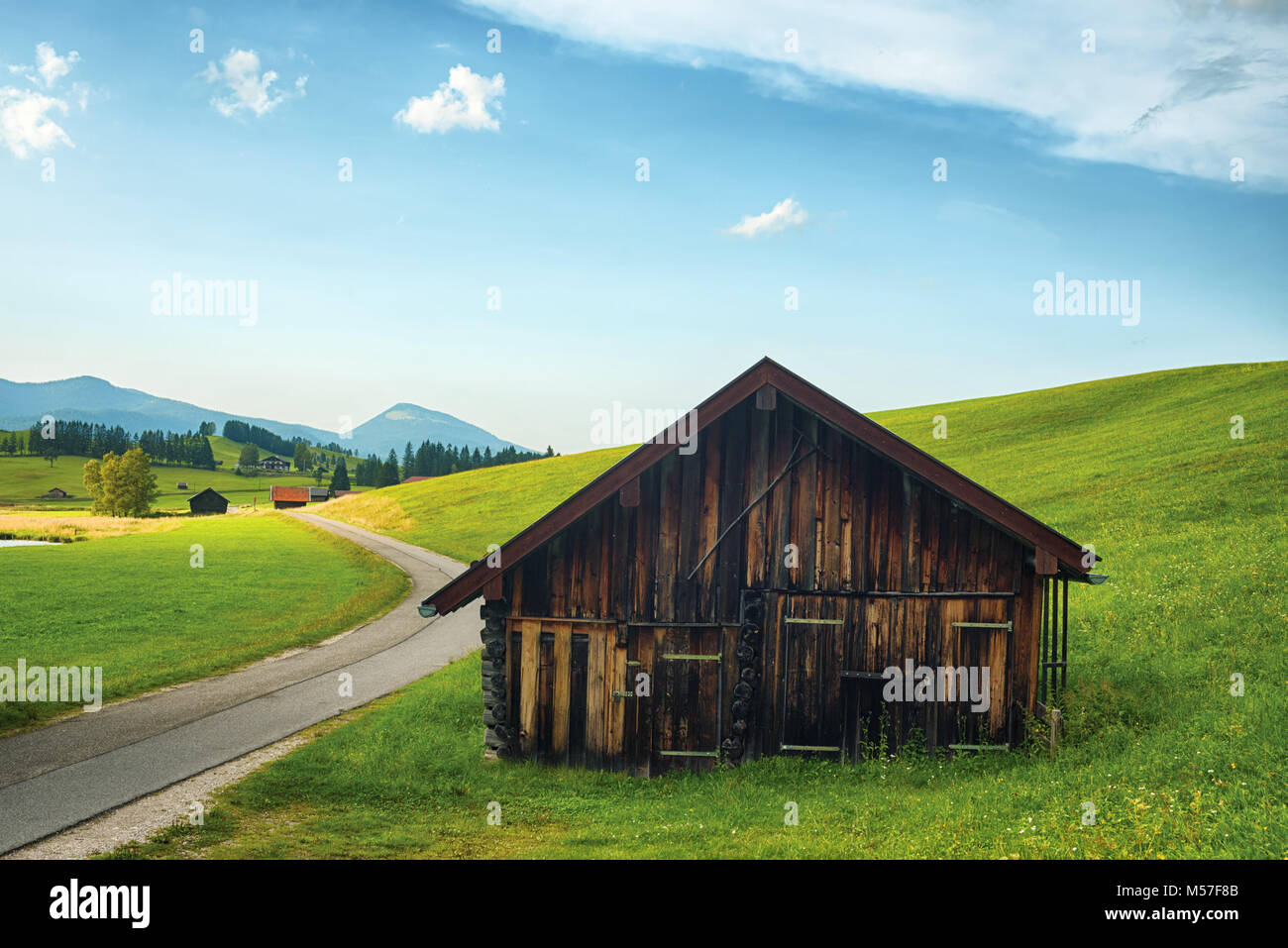 Front view of old dark wooden barn on a green field by the road Stock ...