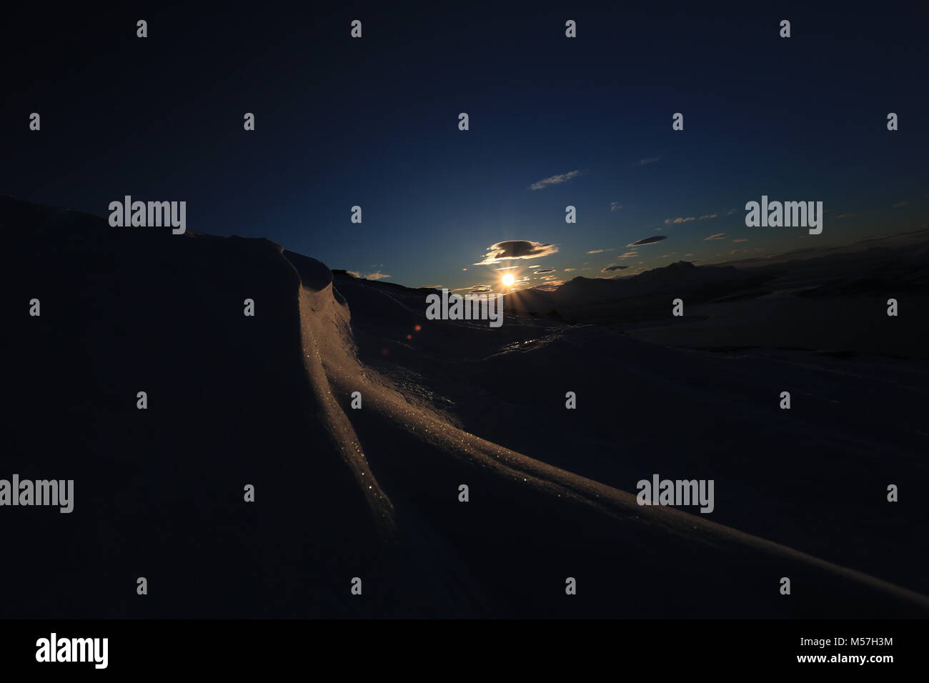 Sun Burst Over Mountain , Snow Drift Foreground Stock Photo - Alamy