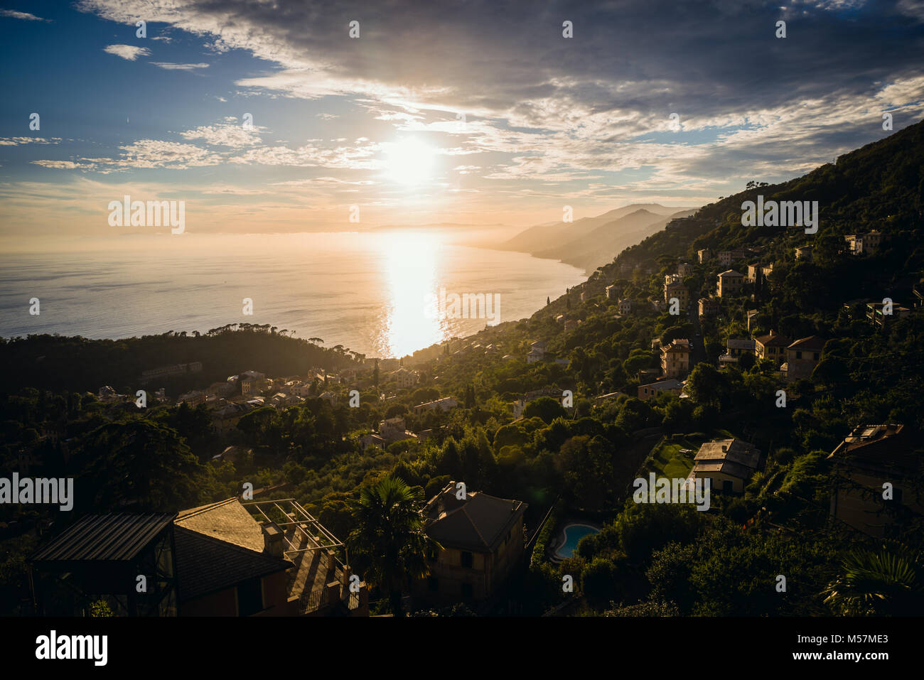 Beautiful sunset view of a village by the sea Stock Photo - Alamy