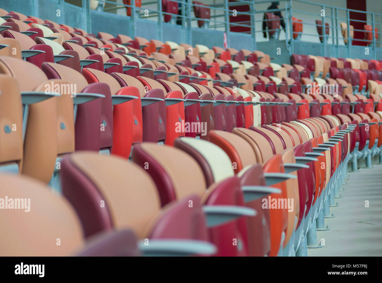 Multi-colored armchairs in a sports stadium Stock Photo - Alamy