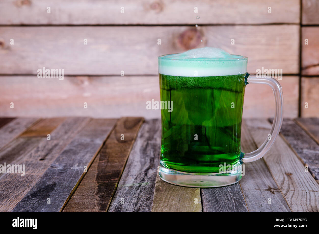 Single mug of green beer on wooden background. Tabletop, front view ...