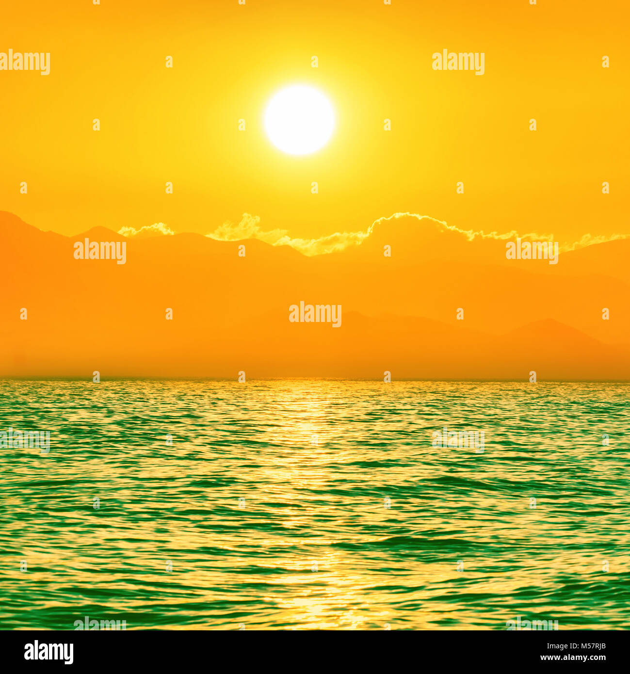 Sunset above the green sea Stock Photo - Alamy