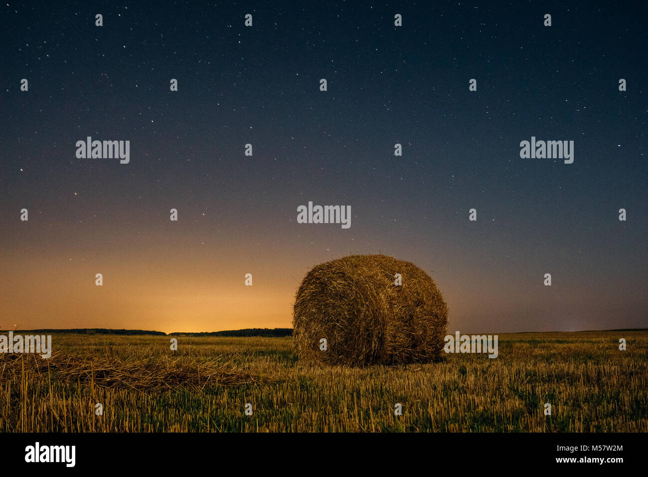 Haystack on the field at night. Night sky with stars in a rural ...