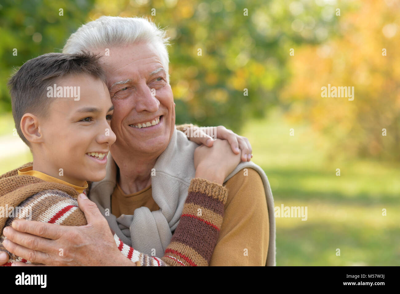 grandfather and grandson hugging in park Stock Photo - Alamy