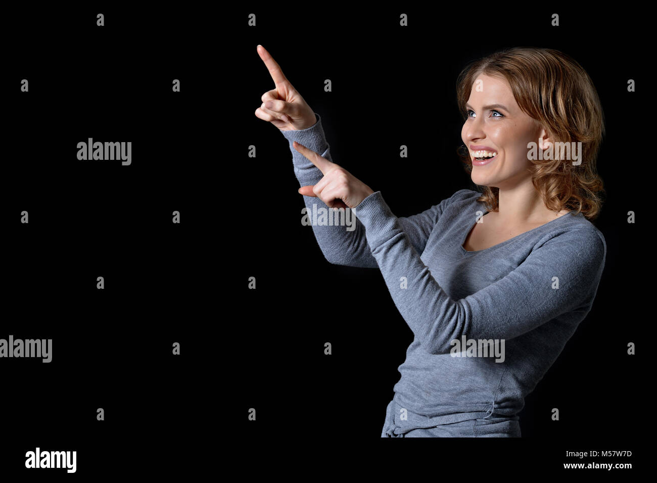 young woman showing something Stock Photo - Alamy