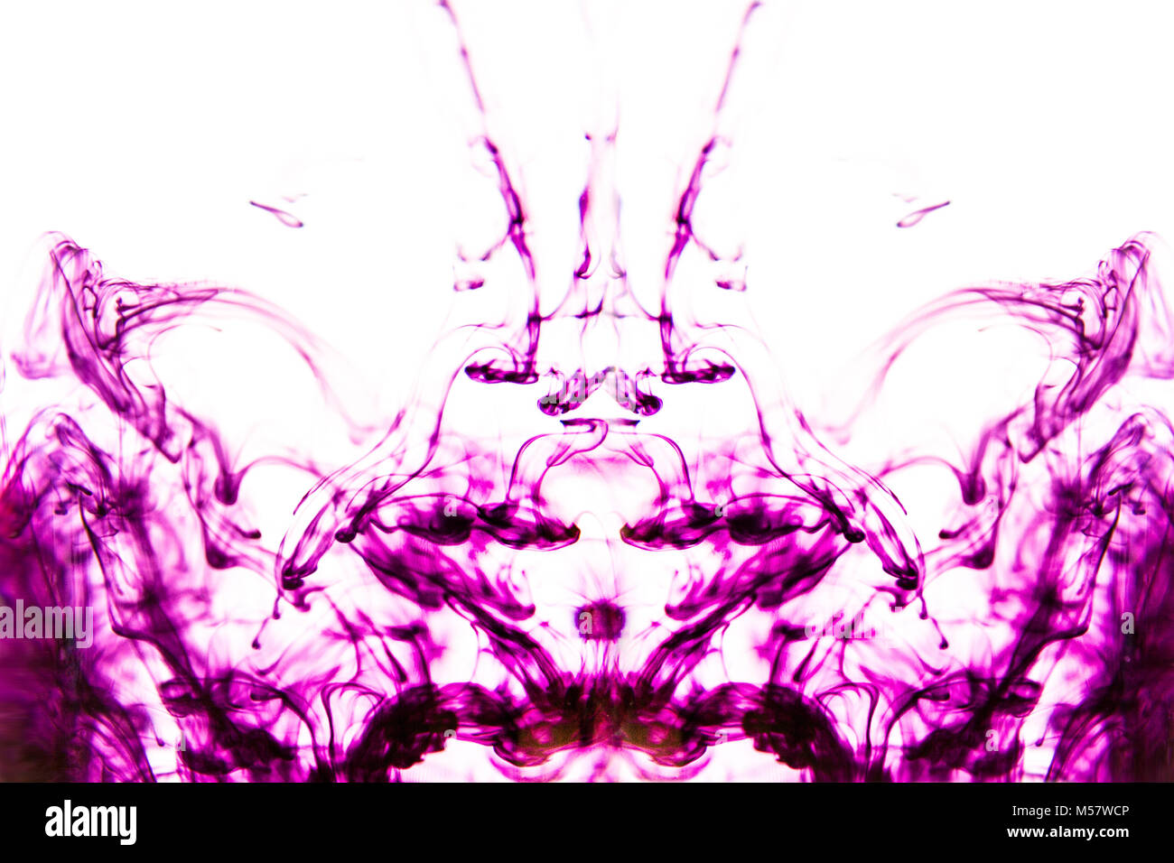 Abstract patterns and shapes made by adding purple colours to water ...