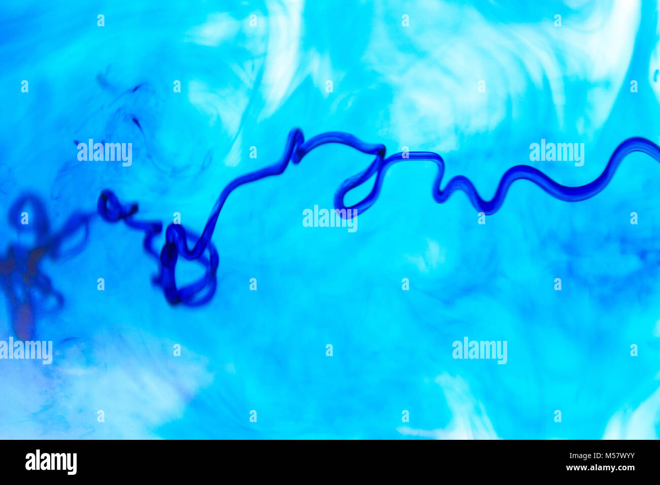 Abstract single blue lines made by ink in water Stock Photo - Alamy