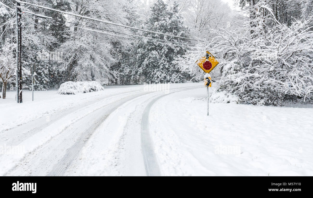 Stop sign on snow covered road iwth trees and telephone pole Stock ...