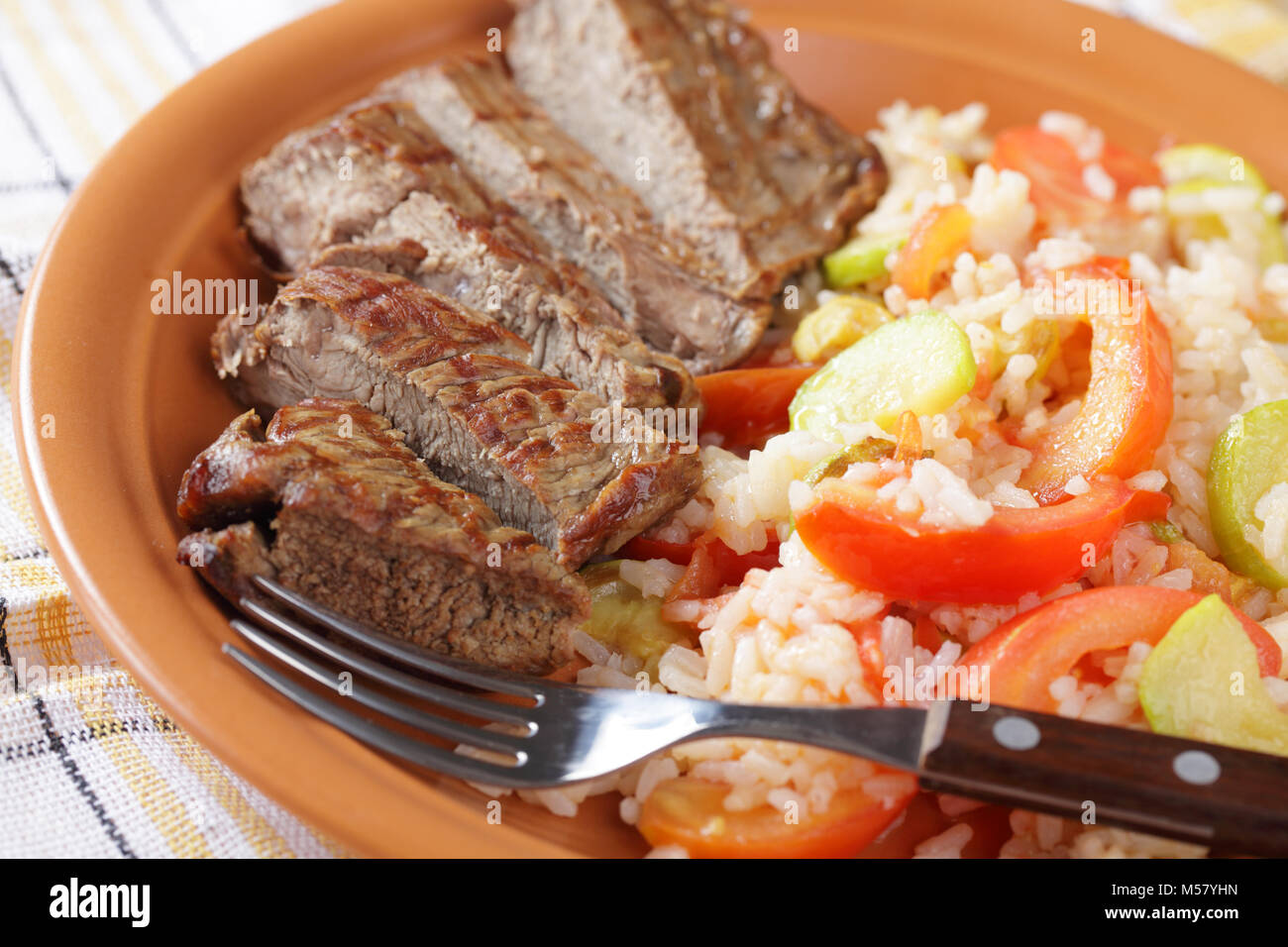 Sliced beef steak with rice and vegetables Stock Photo - Alamy