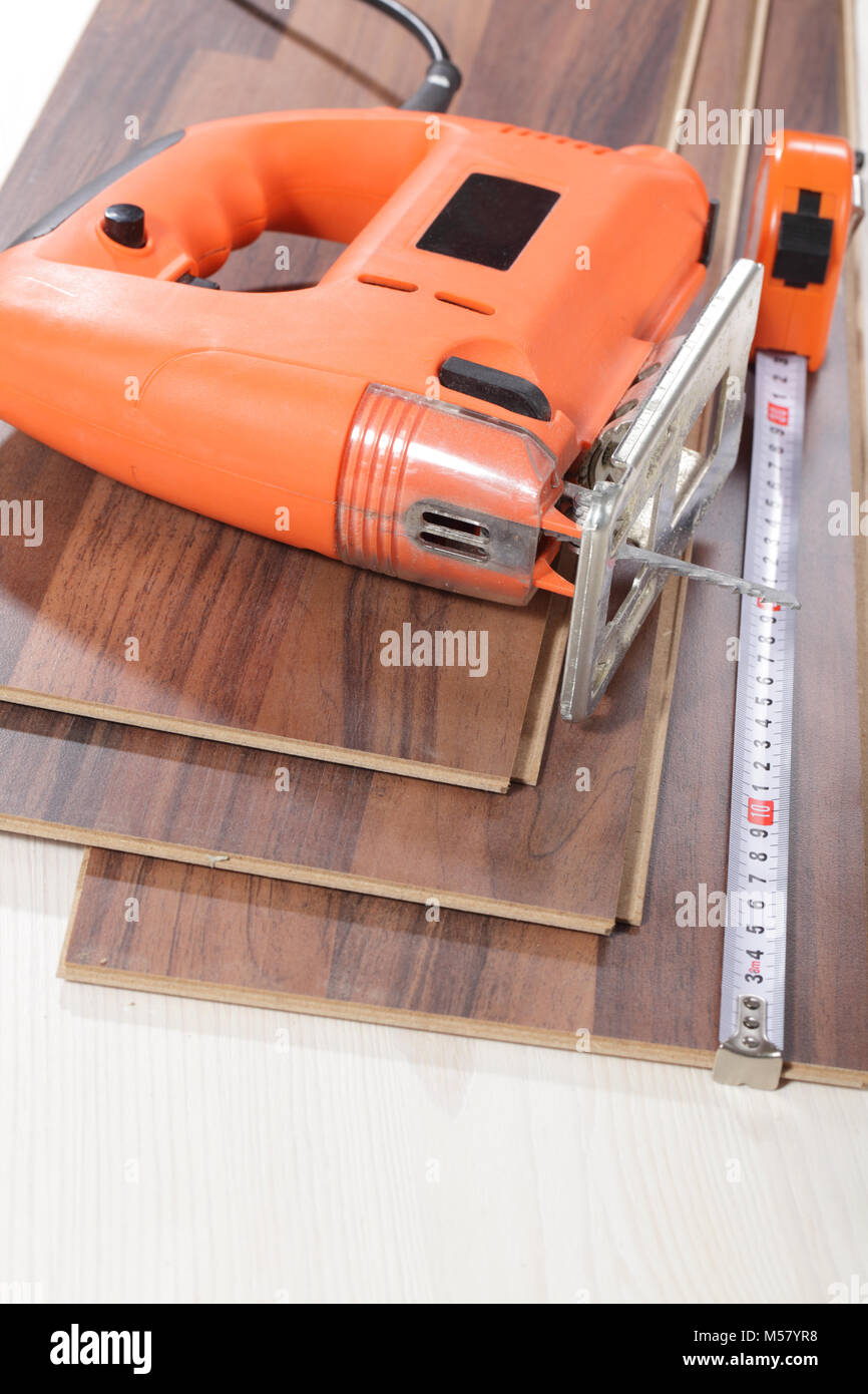 Jigsaw and measuring tape on a stack of laminate panels Stock Photo - Alamy