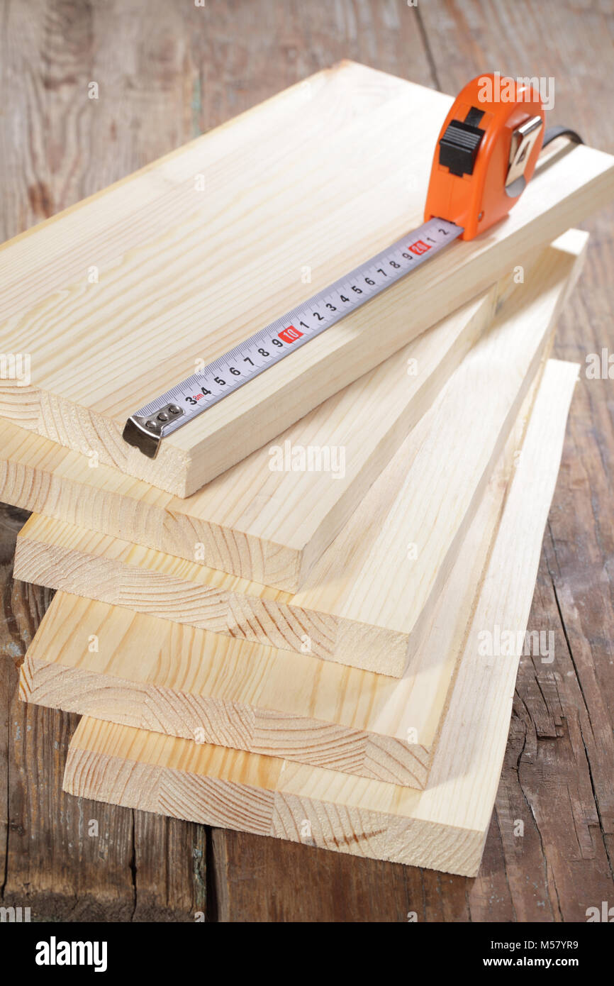 Measuring tape on a stack of wooden planks Stock Photo - Alamy