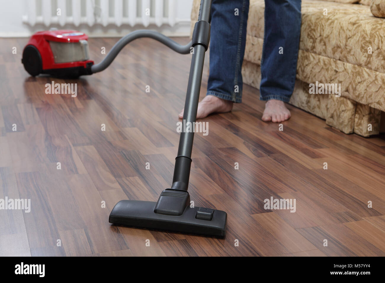 Man vacuuming a floor at home Stock Photo - Alamy