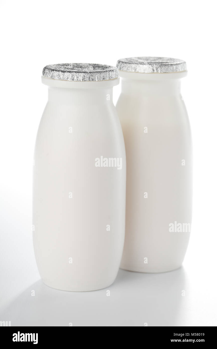 Two yogurt bottles against white background Stock Photo - Alamy