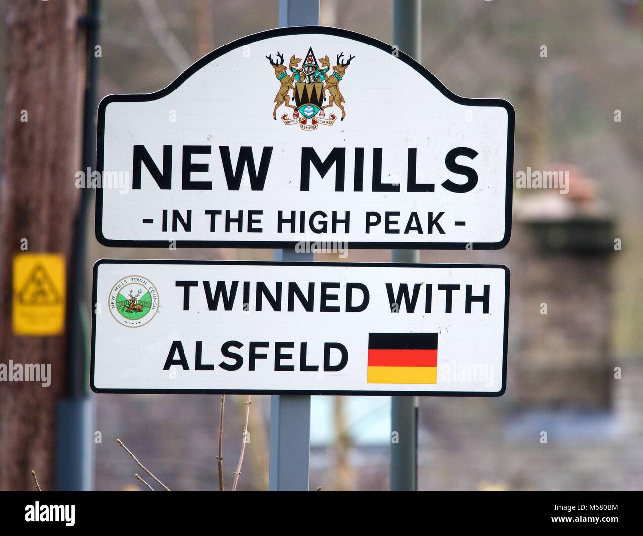 A roads sign showing traffic they are entering New Mills, Derbyshire ...