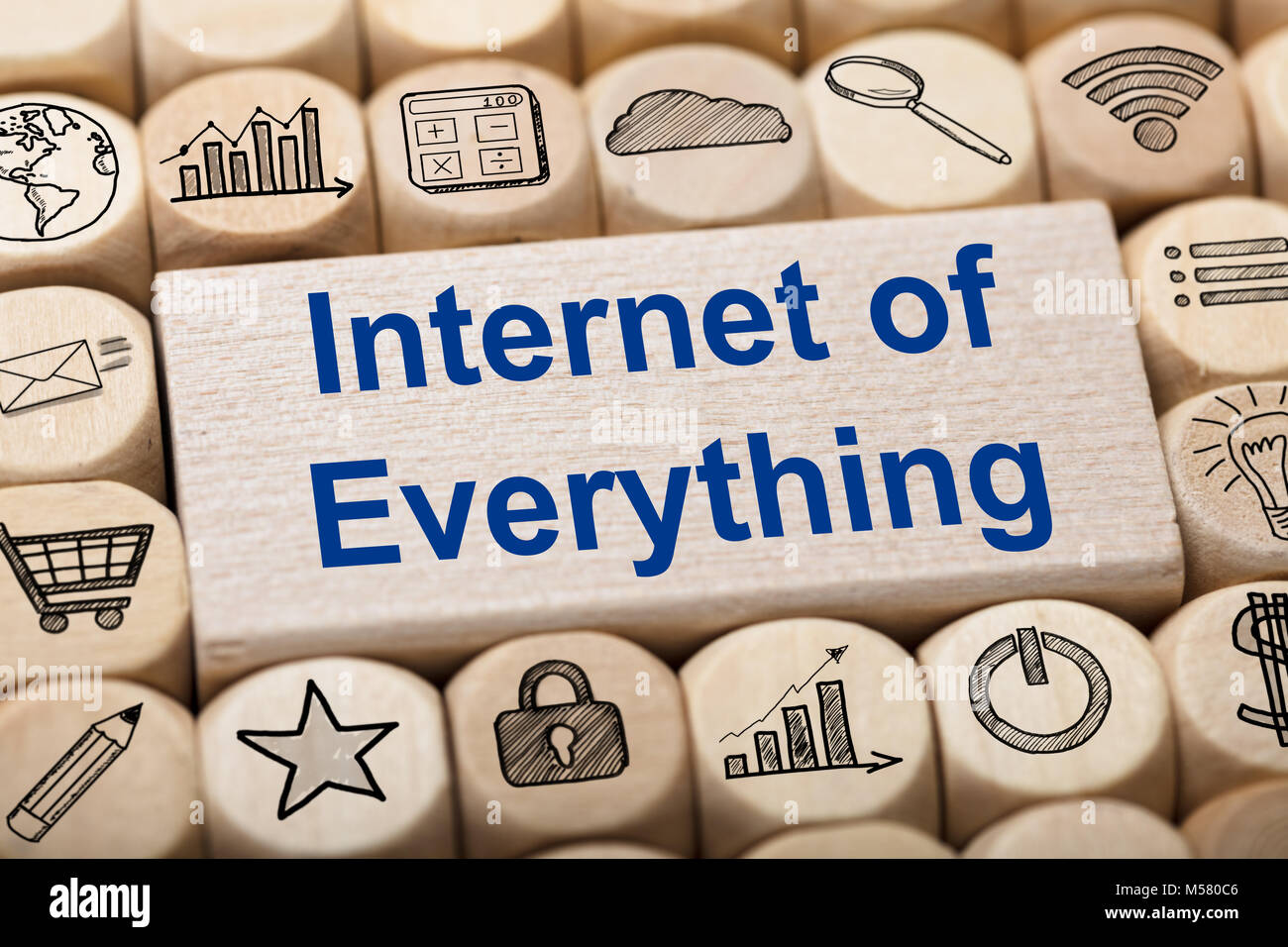 Internet of everything text on wooden block surrounded by various ...