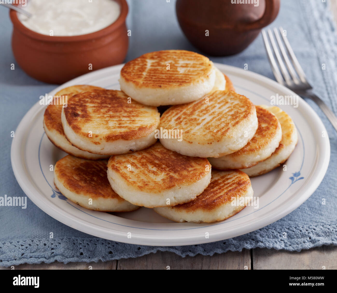 Syrniki The Traditional Russian Cheese Pancakes On A Rustic Table