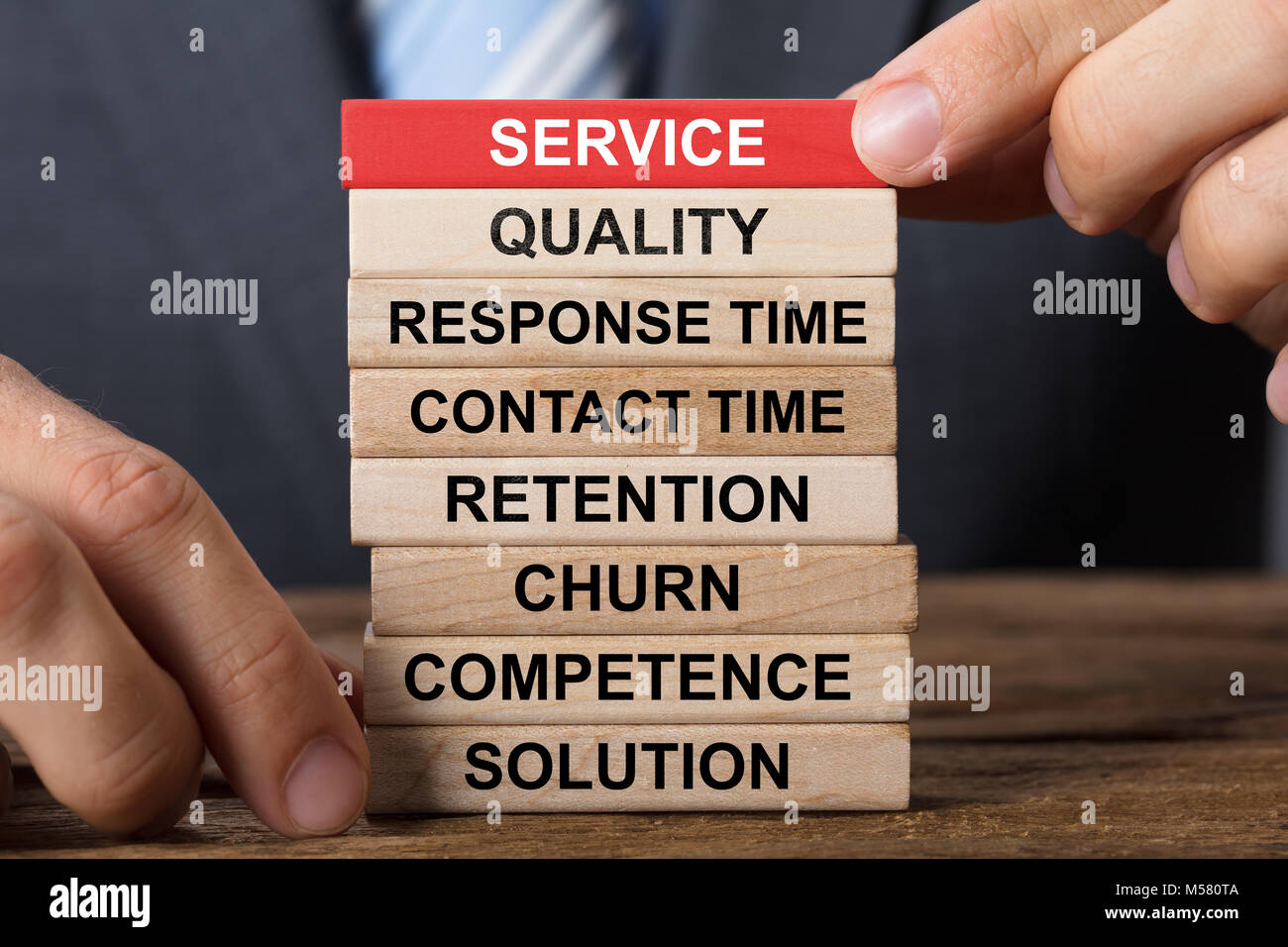 Closeup of businessman building service concept with wooden blocks on ...