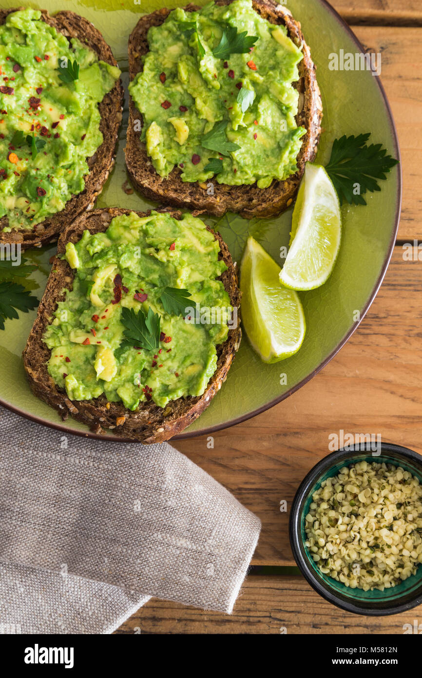 Avocado on toast with topping Stock Photo - Alamy