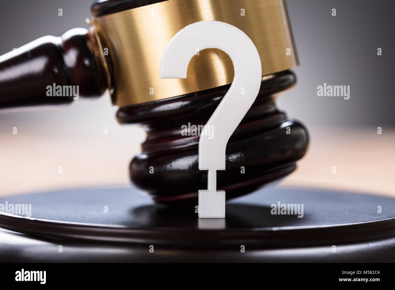 Closeup of question mark and auction gavel Stock Photo - Alamy