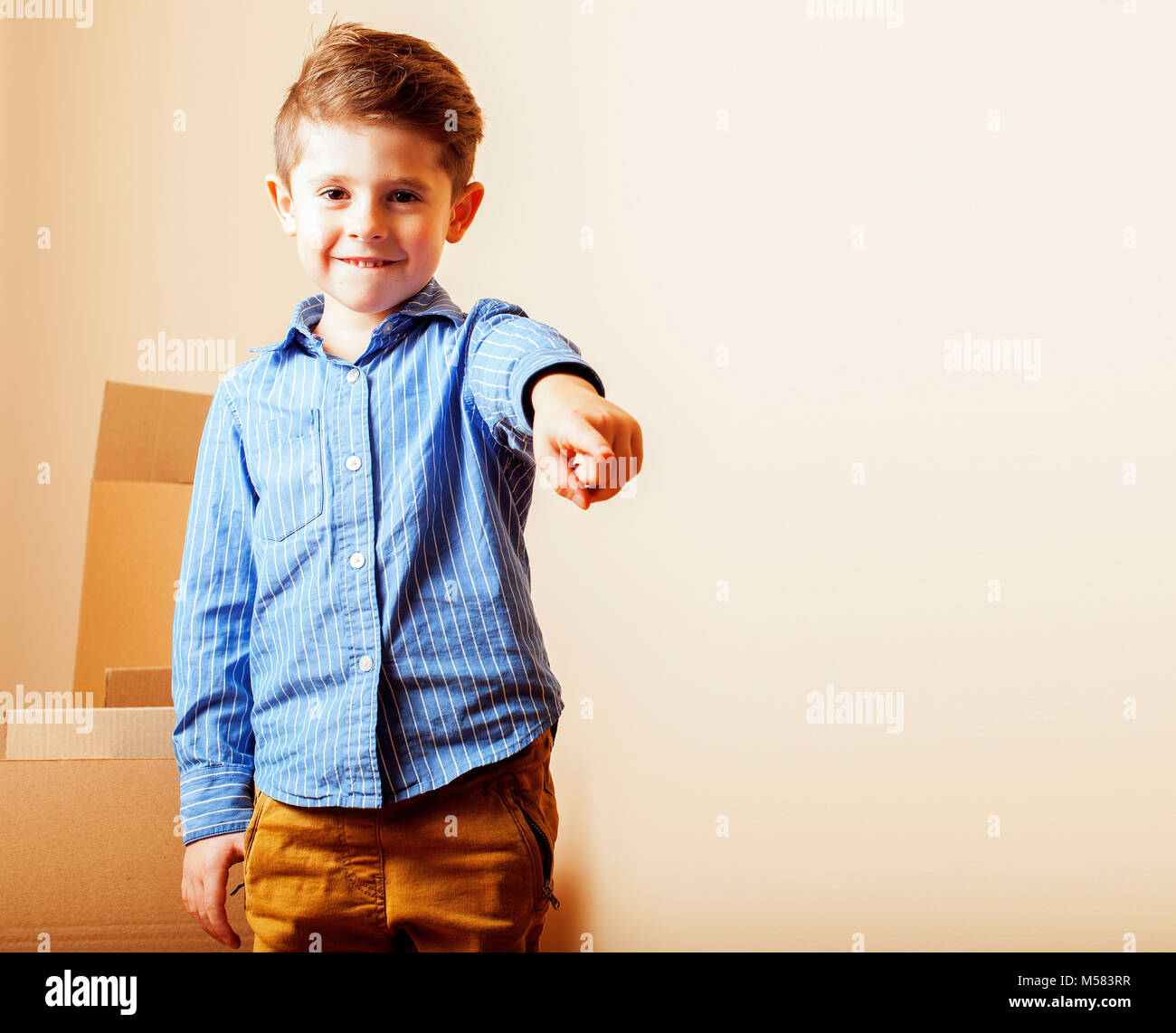 little cute boy in empty room, remoove to new house. home alone Stock ...