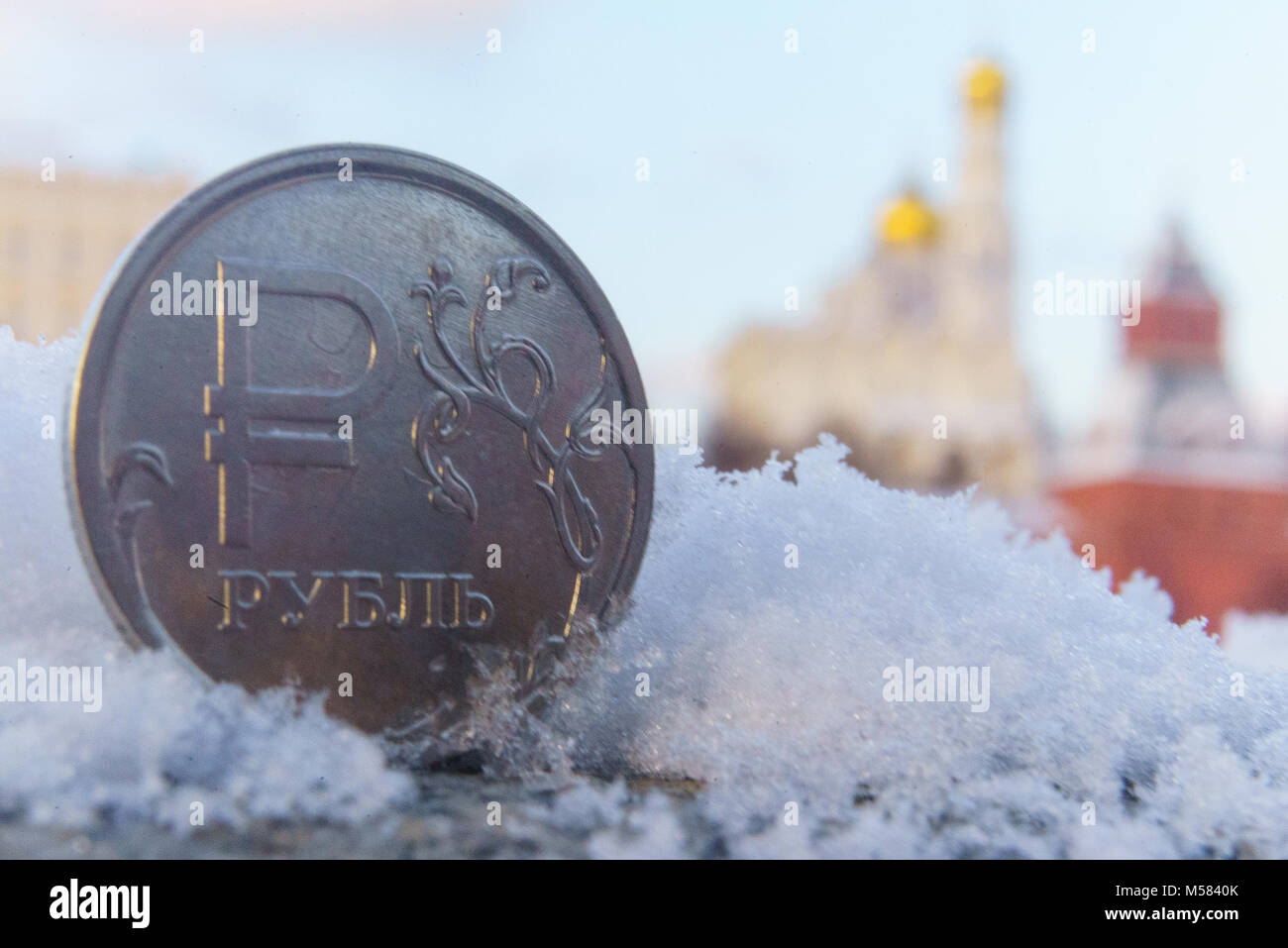 A coin worth one Russian ruble against the backdrop of the Moscow ...
