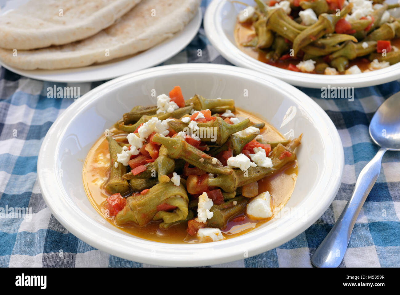 Braised okra with tomato and cheese Stock Photo - Alamy