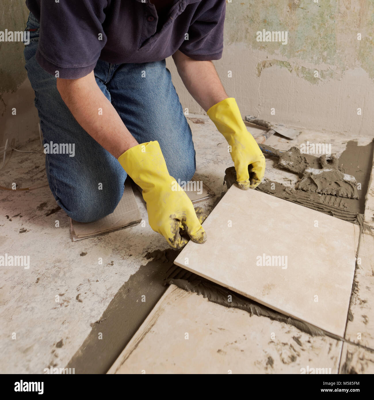 Tiler installs tiles on floor hi-res stock photography and images - Alamy