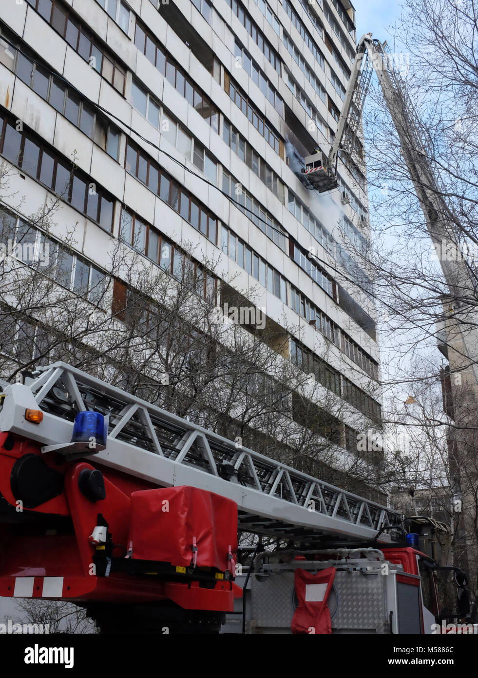 Fire with black smoke in multistory apartment building Stock Photo - Alamy