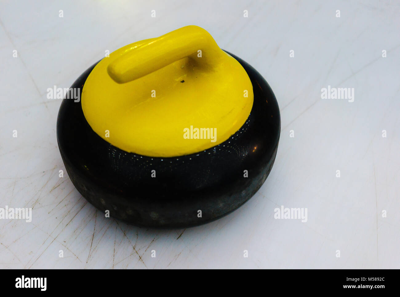 Yellow stone for game in Curling Stock Photo - Alamy