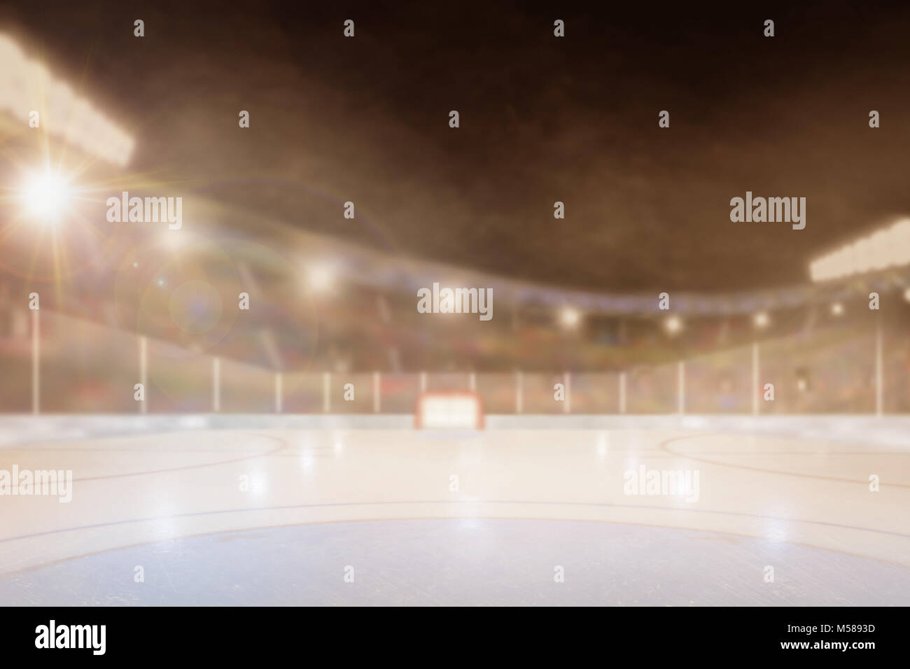 Brightly lit outdoor ice hockey rink arena with focus on foreground and ...