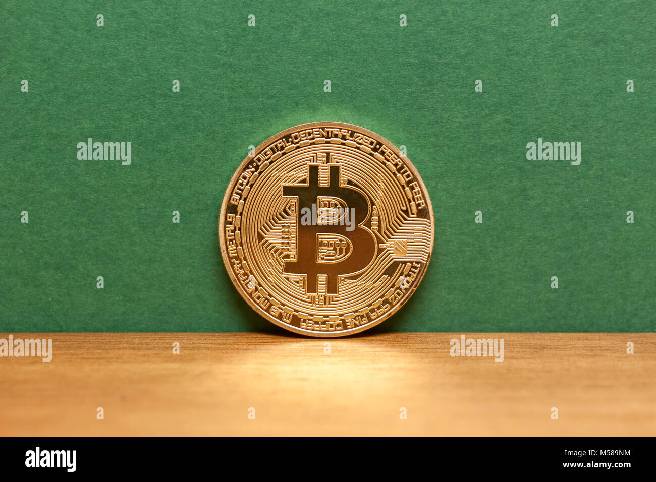 golden bitcoin coin green background Stock Photo - Alamy