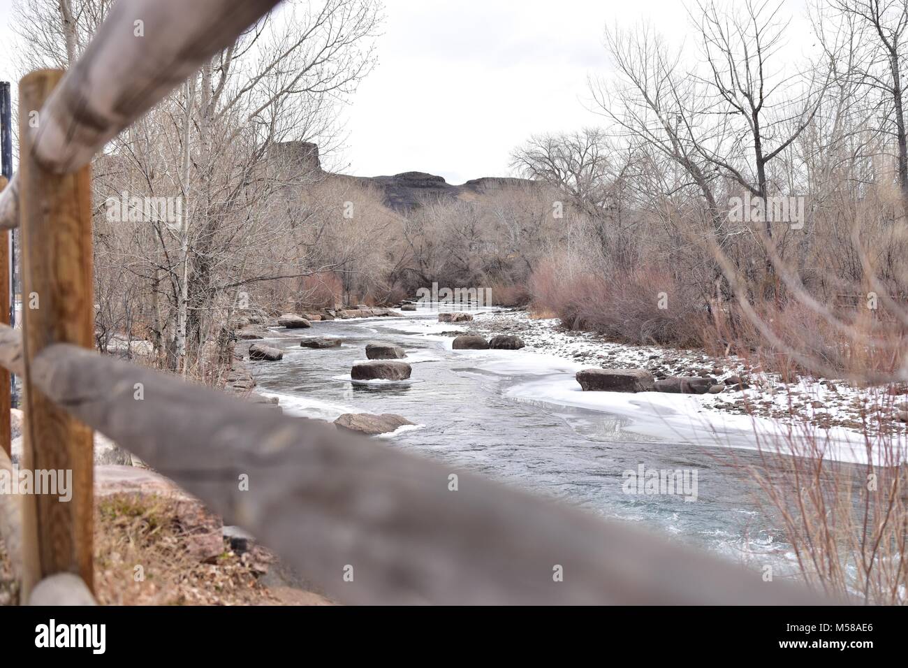 River Through Fence Stock Photo - Alamy